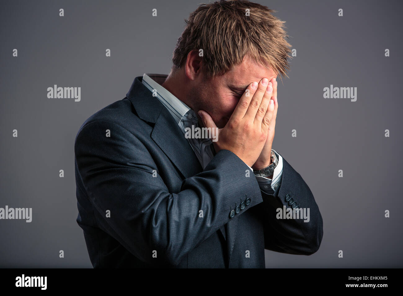 Businessman in depression with hands on forehead, hoping for better ...