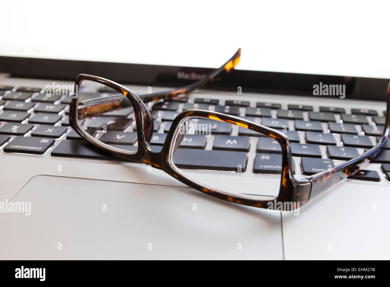 Reading glasses on laptop keyboard - USA Stock Photo - Alamy