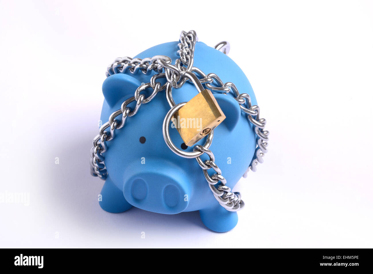Piggy bank tied with the chain Stock Photo - Alamy