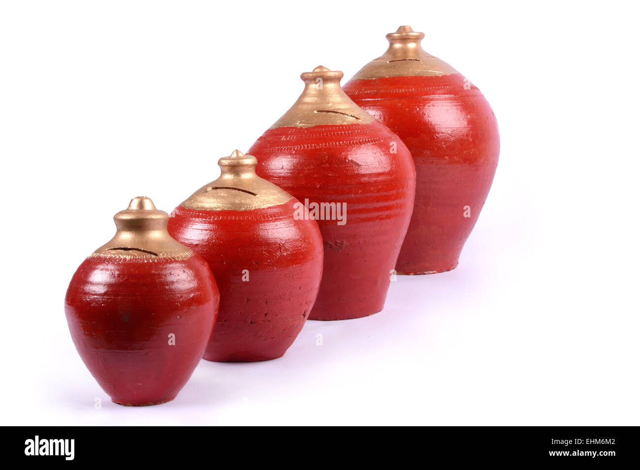 Earthen pot is a coin box of rural India called Gullak, in the row ...