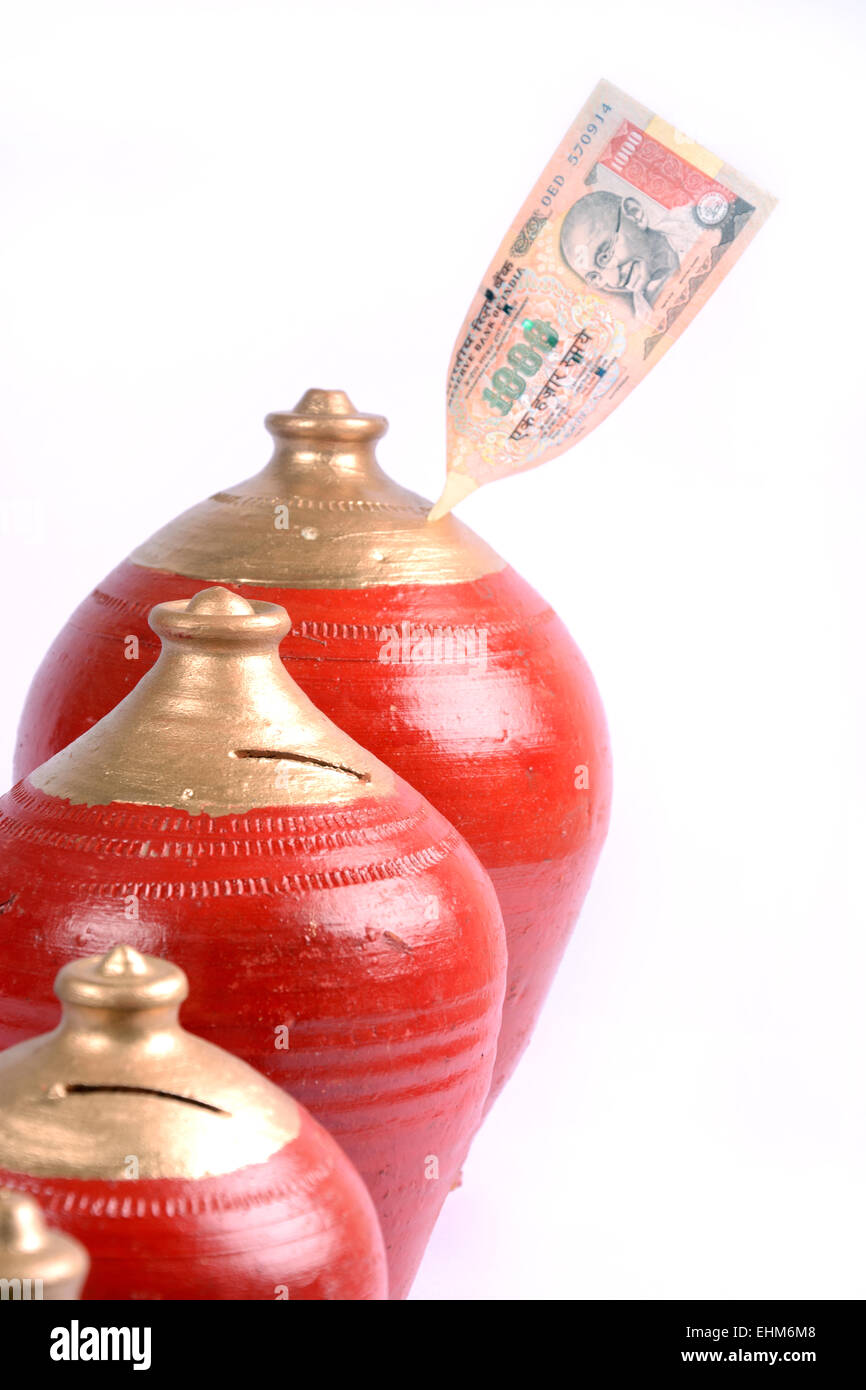 Earthen pot is a coin box of rural India called Gullak, with one ...