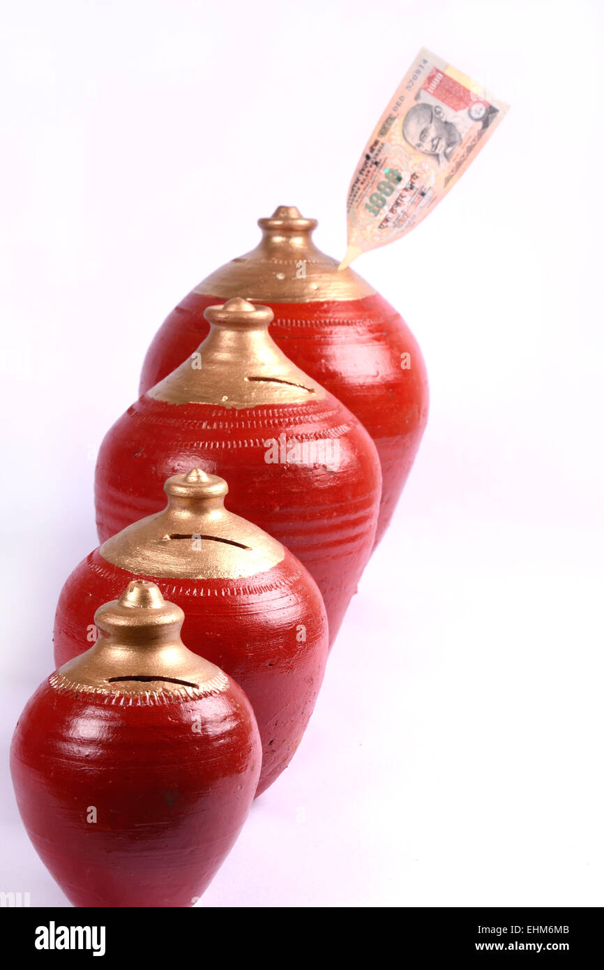 Earthen pot is a coin box of rural India called Gullak, with one ...