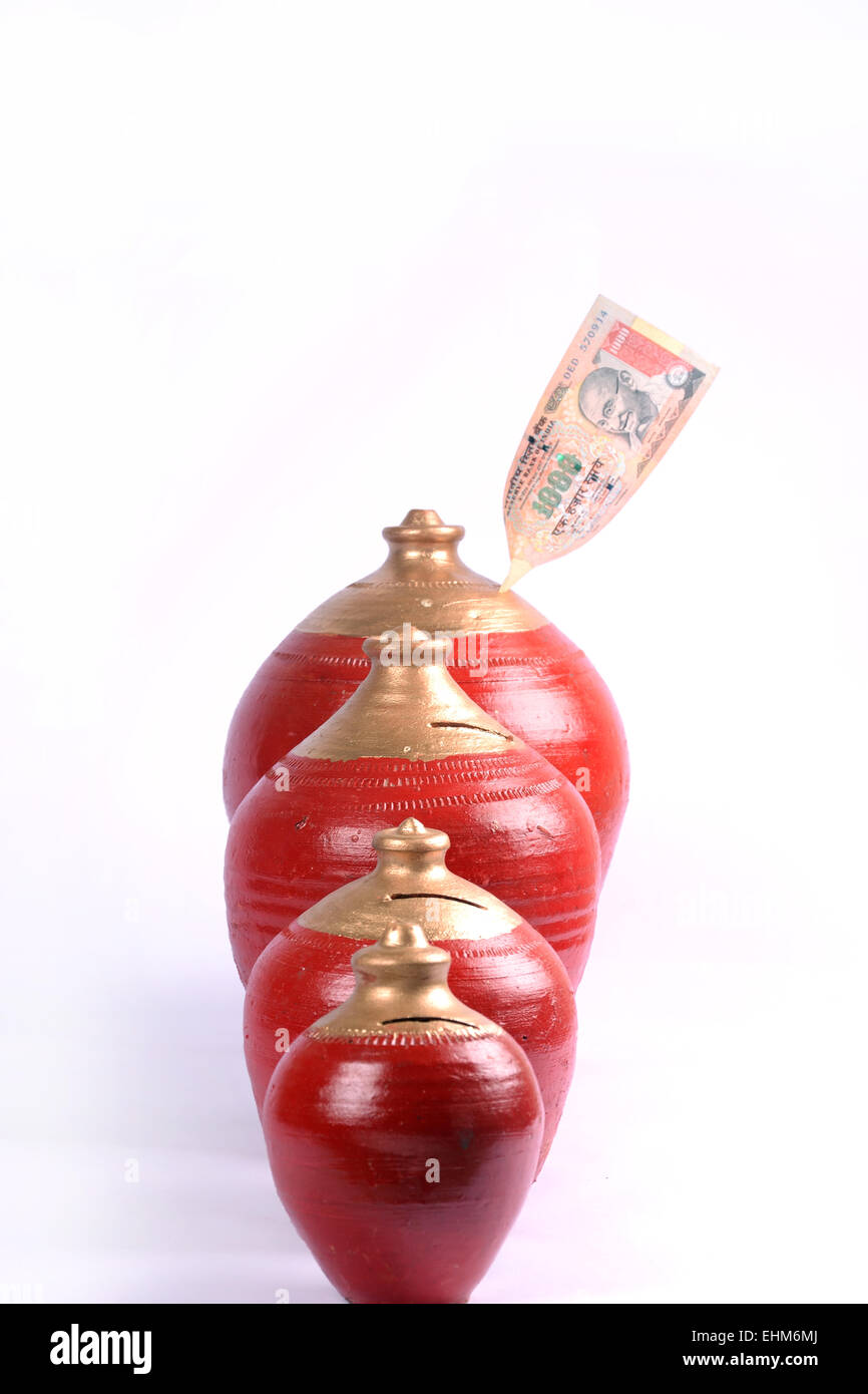 Earthen pot is a coin box of rural India called Gullak, with one ...