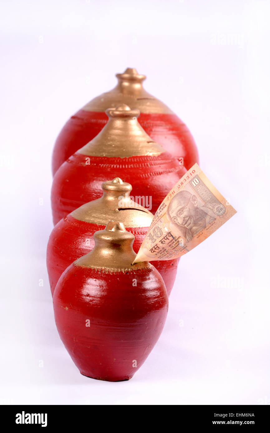 Earthen pot is a coin box of rural India called Gullak Stock Photo - Alamy