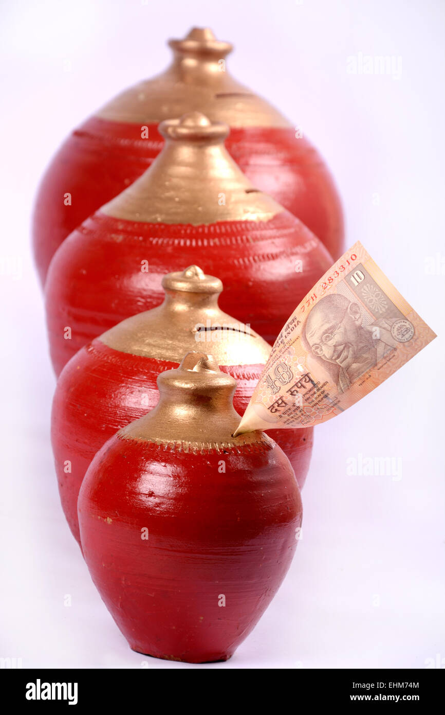 Earthen pot is a coin box of rural India called Gullak Stock Photo - Alamy