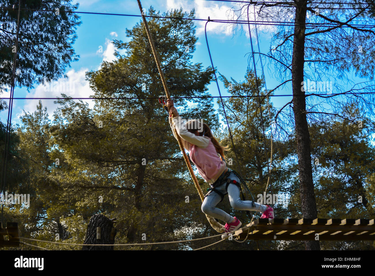 A little Girl completing a course at Adventure Park Stock Photo - Alamy