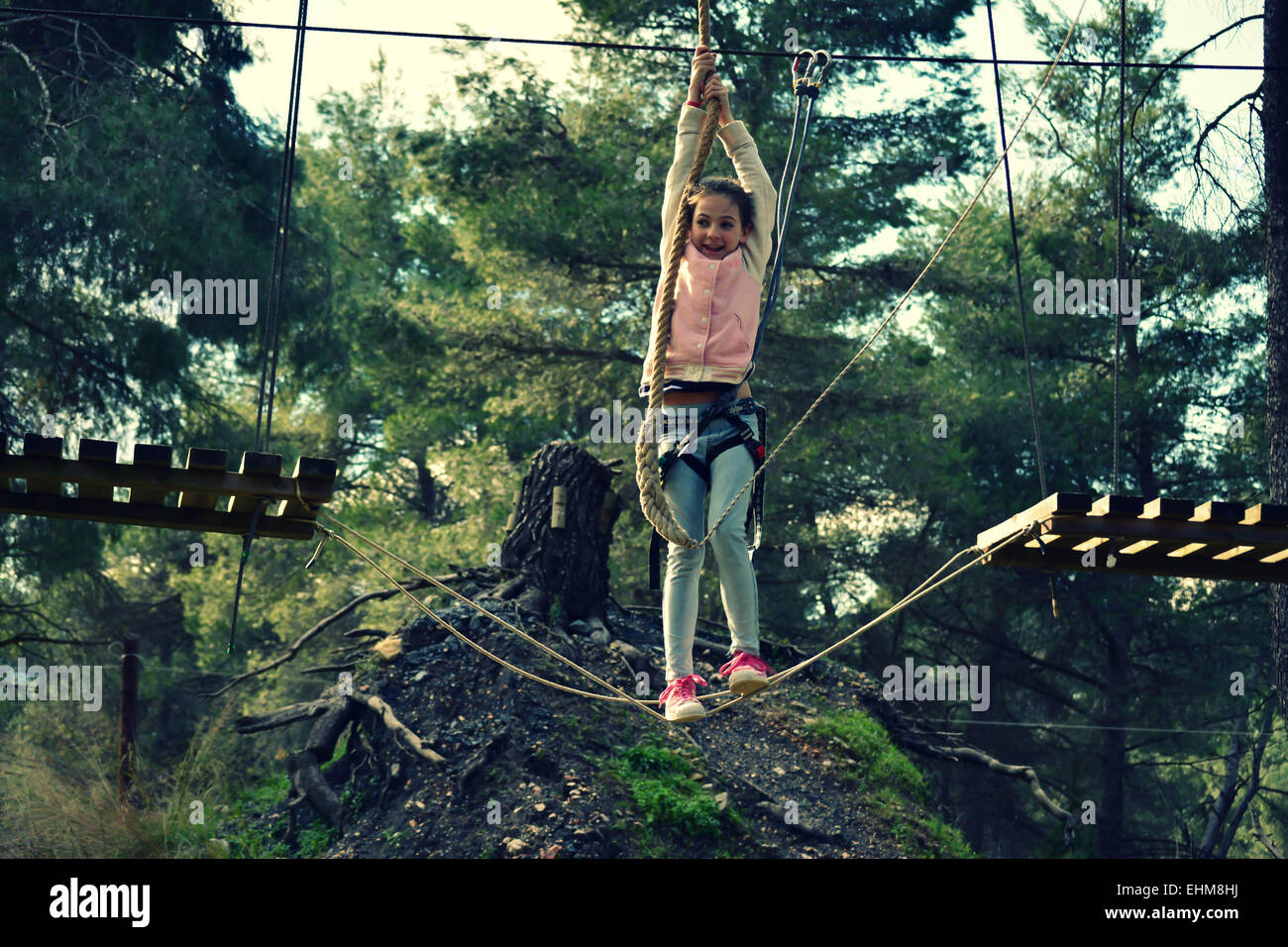 A little Girl completing a course at Adventure Park Stock Photo - Alamy