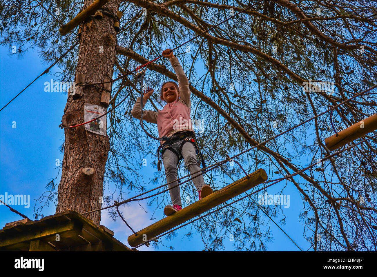 A little Girl completing a course at Adventure Park Stock Photo - Alamy