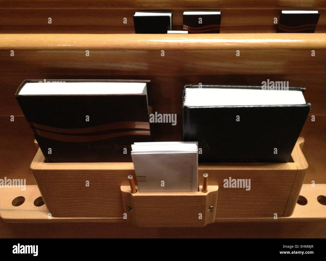 Close up of Bibles in holder behind church pew Stock Photo - Alamy