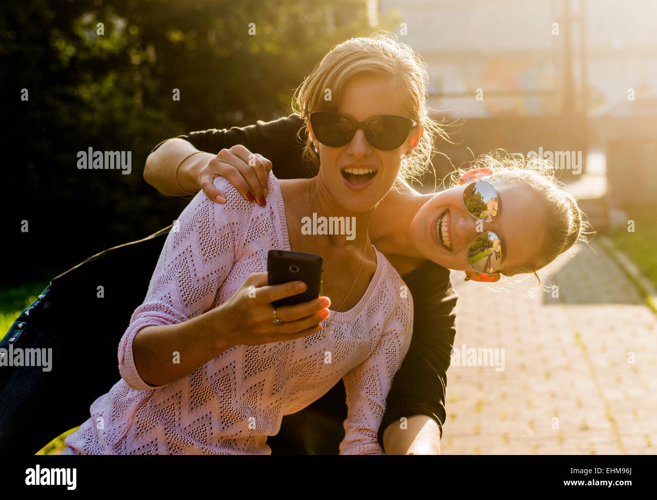 Caucasian women taking cell phone selfie Stock Photo - Alamy