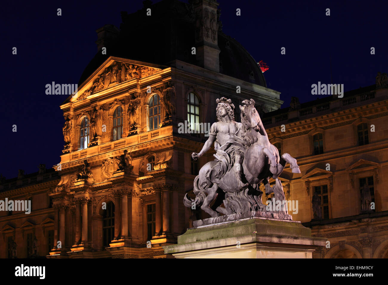 Night view of The Louvre Palace and statue of Louis XIV, Paris, France ...