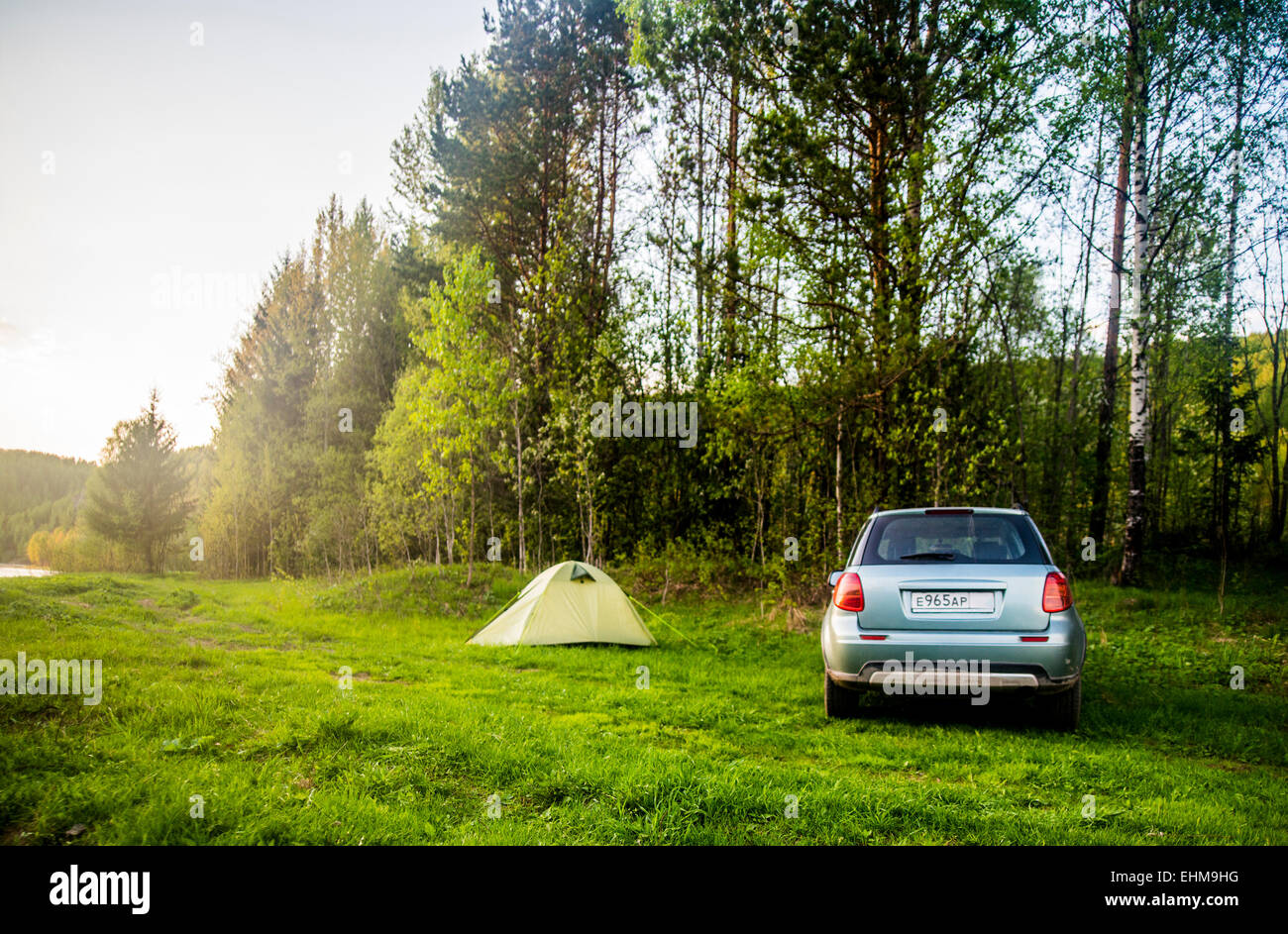 Car and tent at campsite in field Stock Photo - Alamy