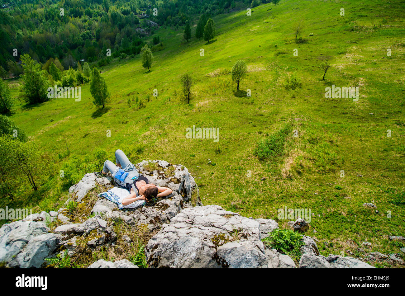 High angle view of Caucasian girl laying on cliff edge Stock Photo - Alamy
