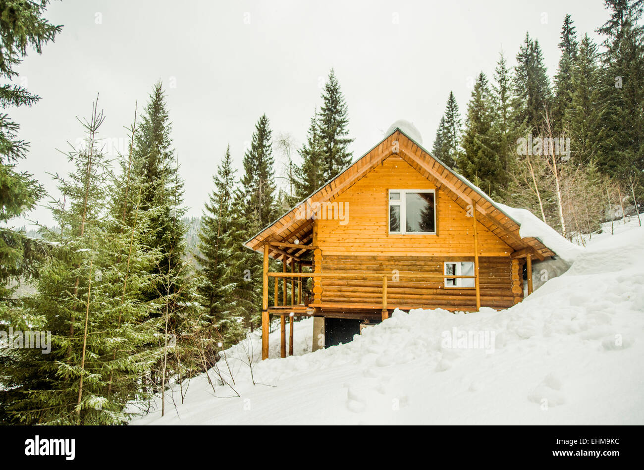 Cabin on snowy remote hillside Stock Photo - Alamy