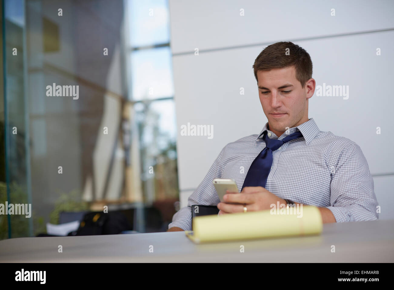 Caucasian businessman using cell phone in office Stock Photo - Alamy
