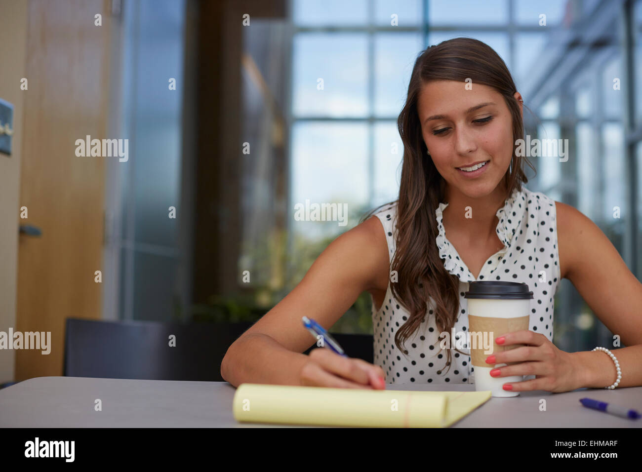 Young business woman holding notepad Stock Photo - Alamy