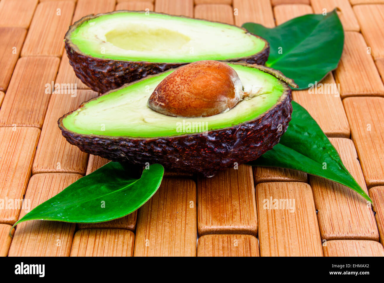 Composition of several avocados on a wood background Stock Photo - Alamy