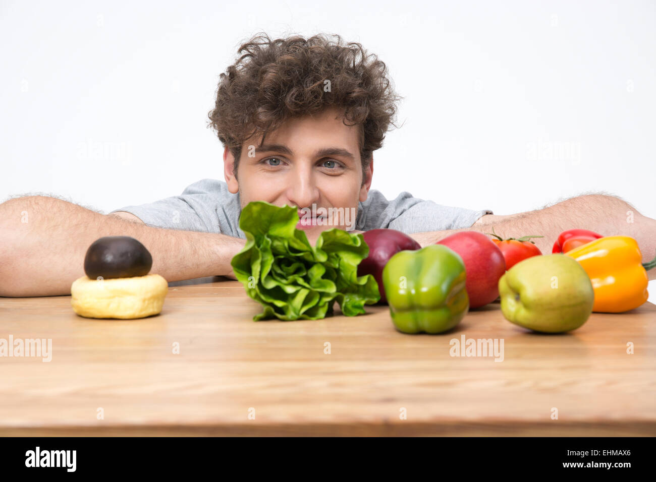 Young man sitting at the table with food Stock Photo - Alamy