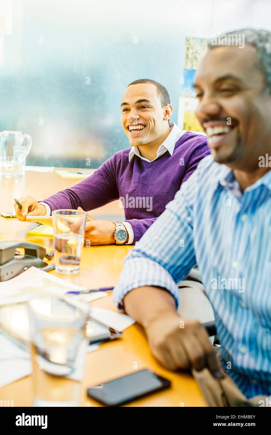 Businessmen laughing in office meeting Stock Photo - Alamy
