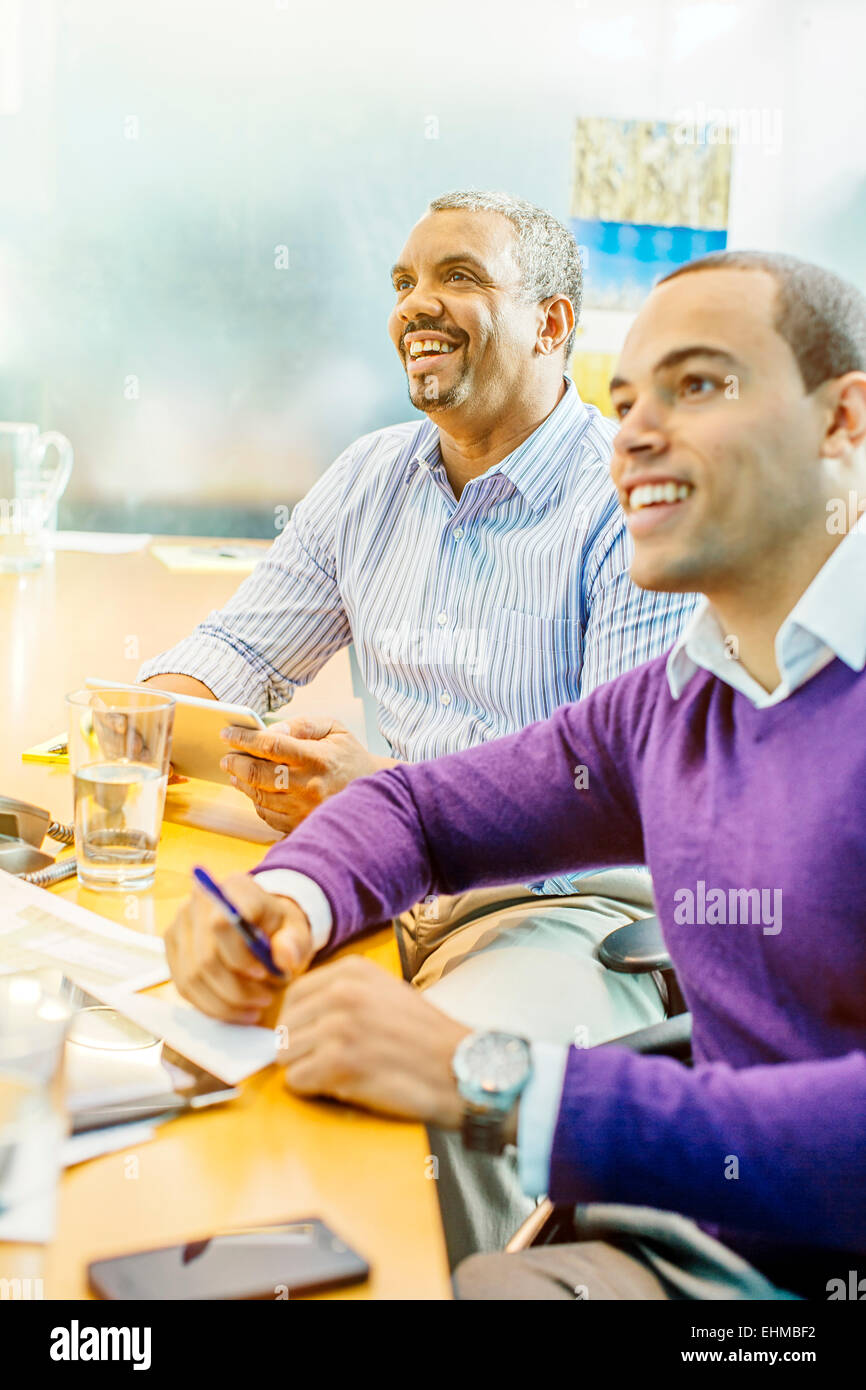 Businessmen laughing in office meeting Stock Photo - Alamy