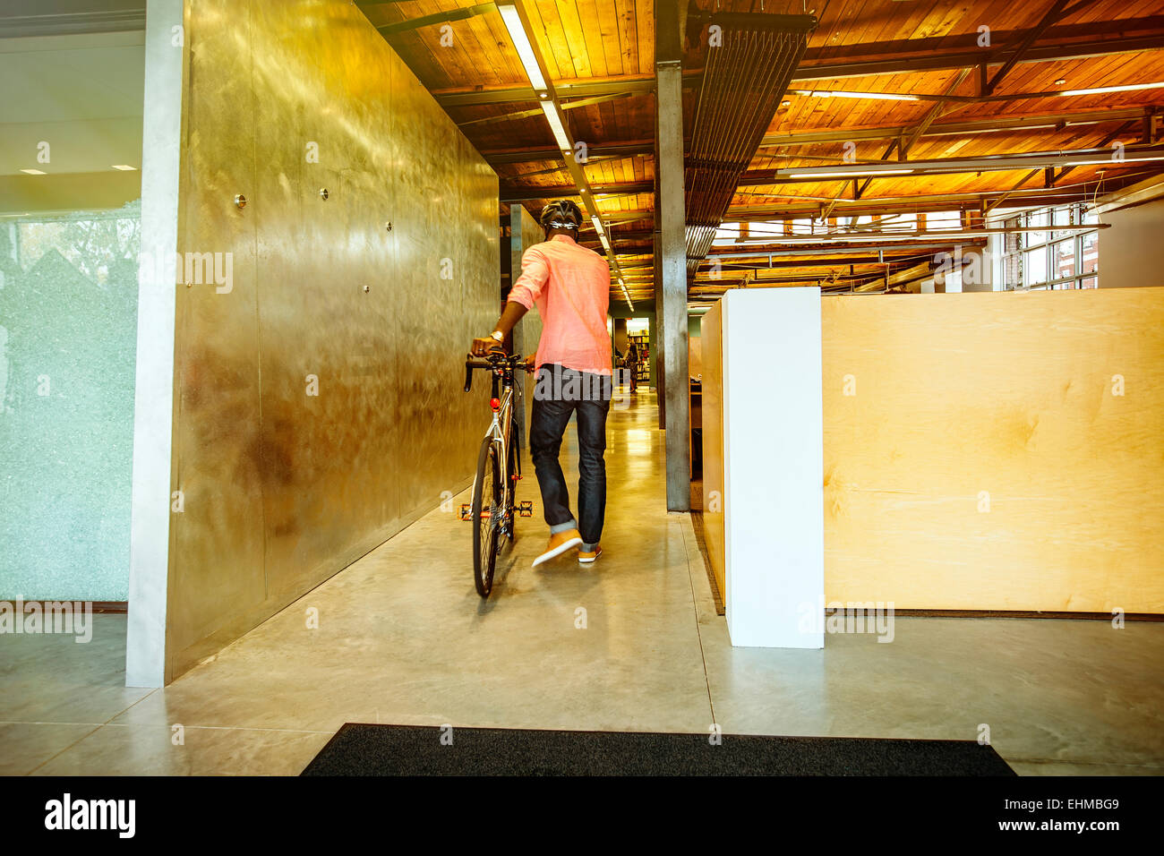 African American businessman pushing bicycle into office Stock Photo ...