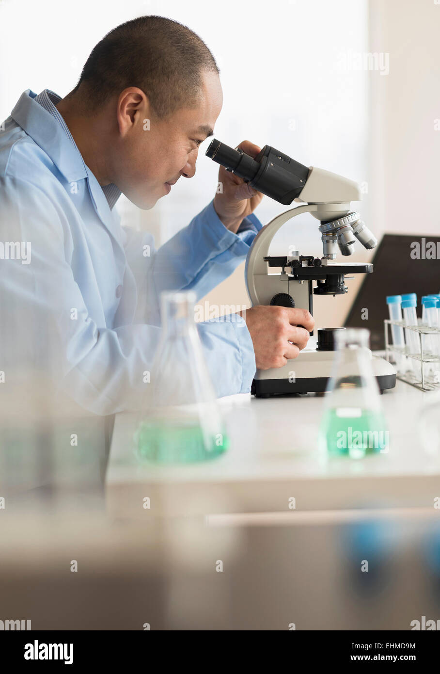 Korean scientist using microscope in laboratory Stock Photo - Alamy