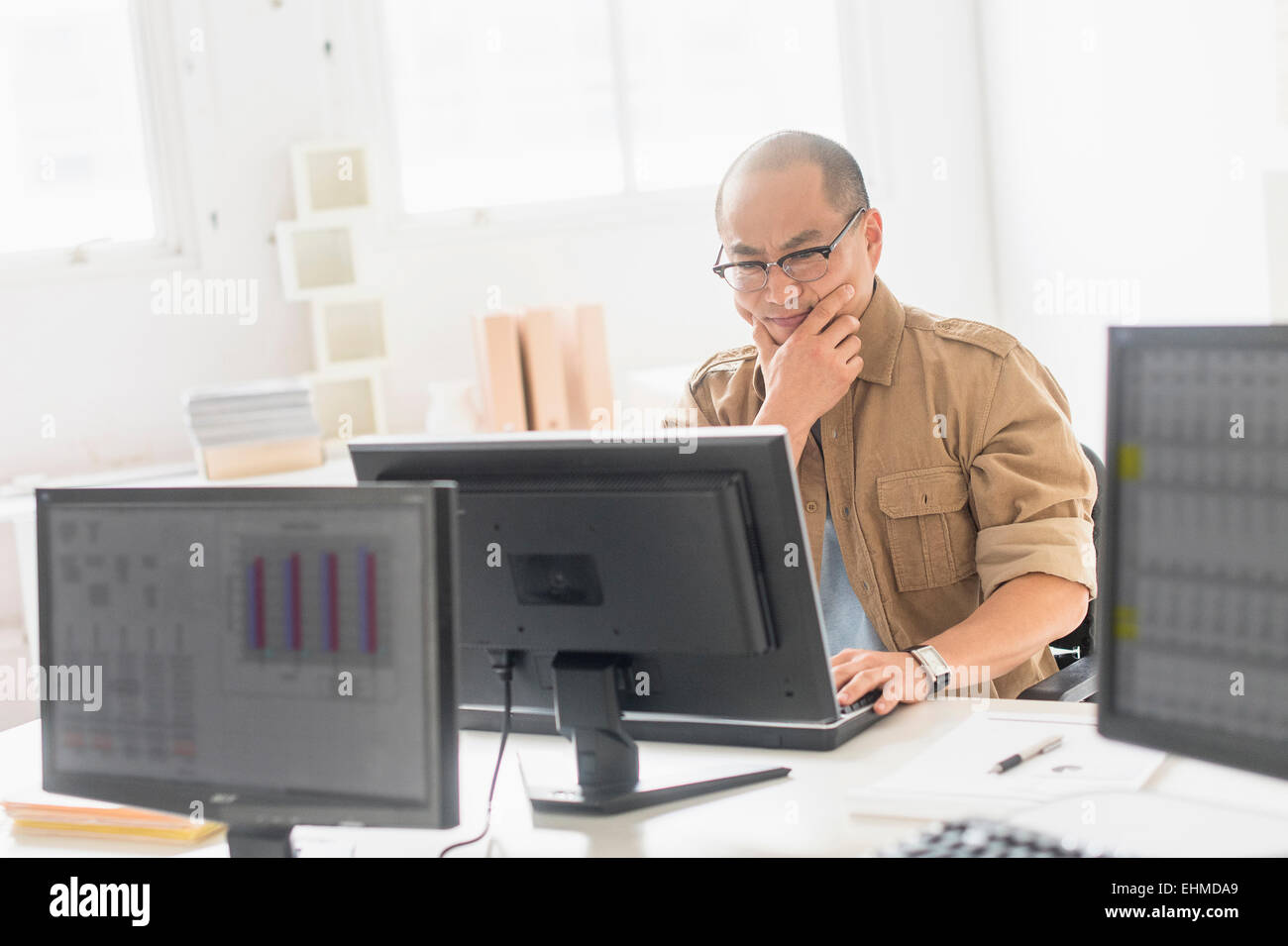 Korean businessman working on computer at office desk Stock Photo - Alamy