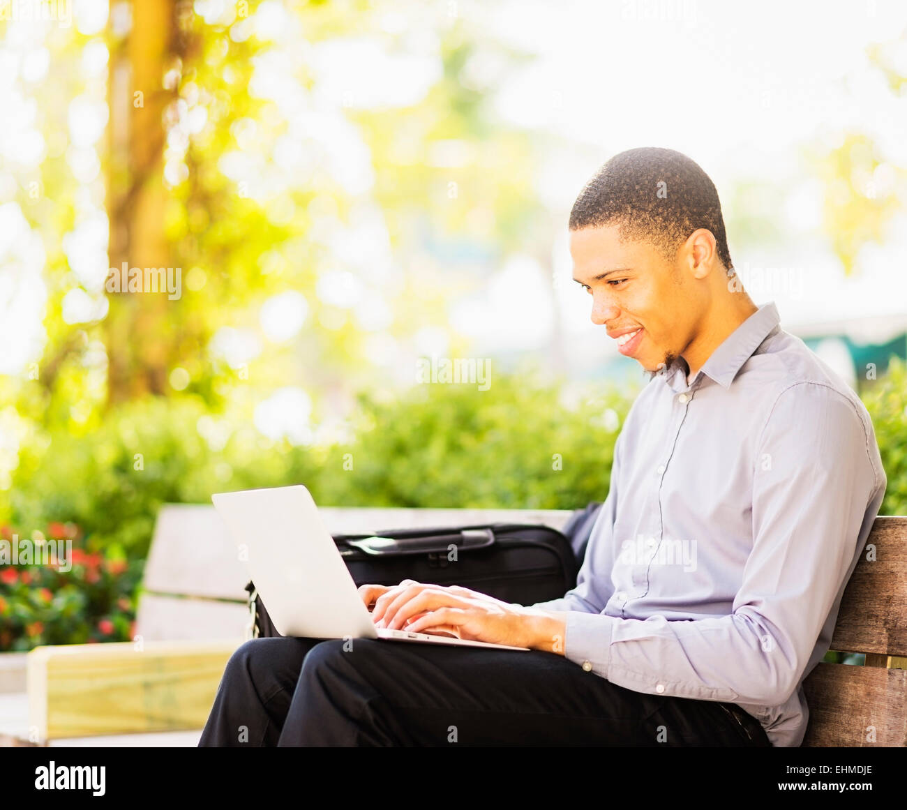 Black businessman using laptop outdoors Stock Photo - Alamy