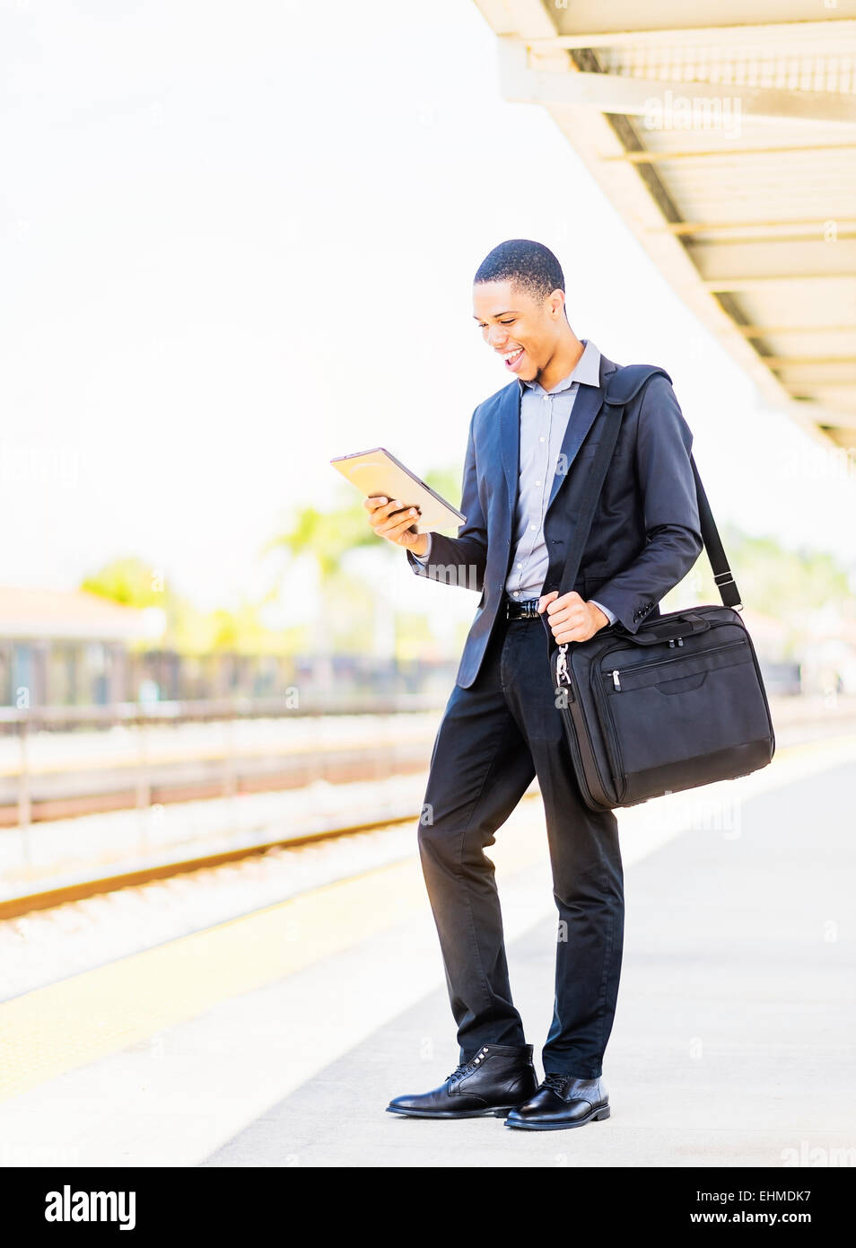Black businessman using digital tablet on train platform Stock Photo ...