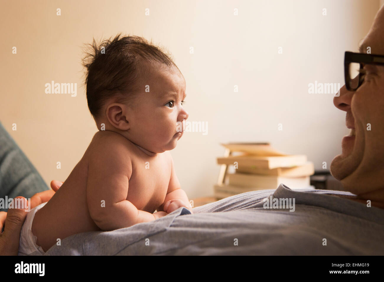 Smiling father playing with baby Stock Photo - Alamy