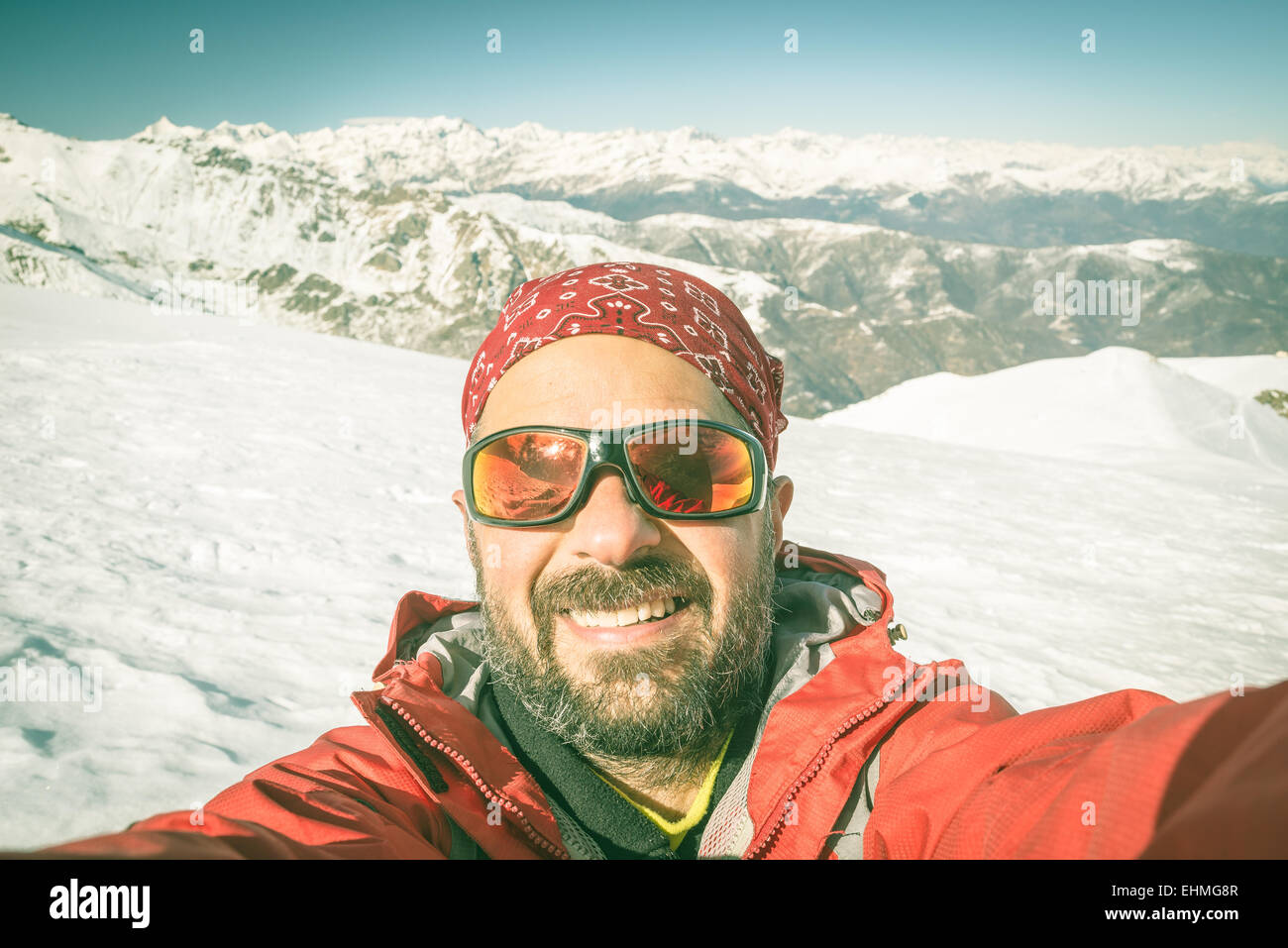 Adult european man taking selfie on snowy slope with the beautiful ...