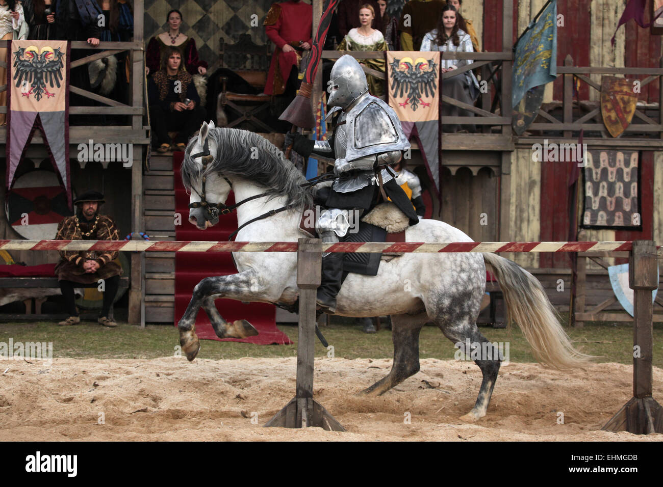 Actor dressed as a medieval knight rides a horse during the filming of ...