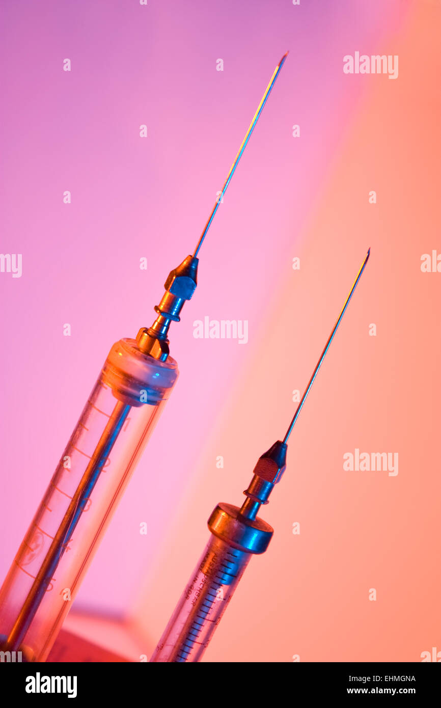 old glass syringe multicolored lights Stock Photo - Alamy