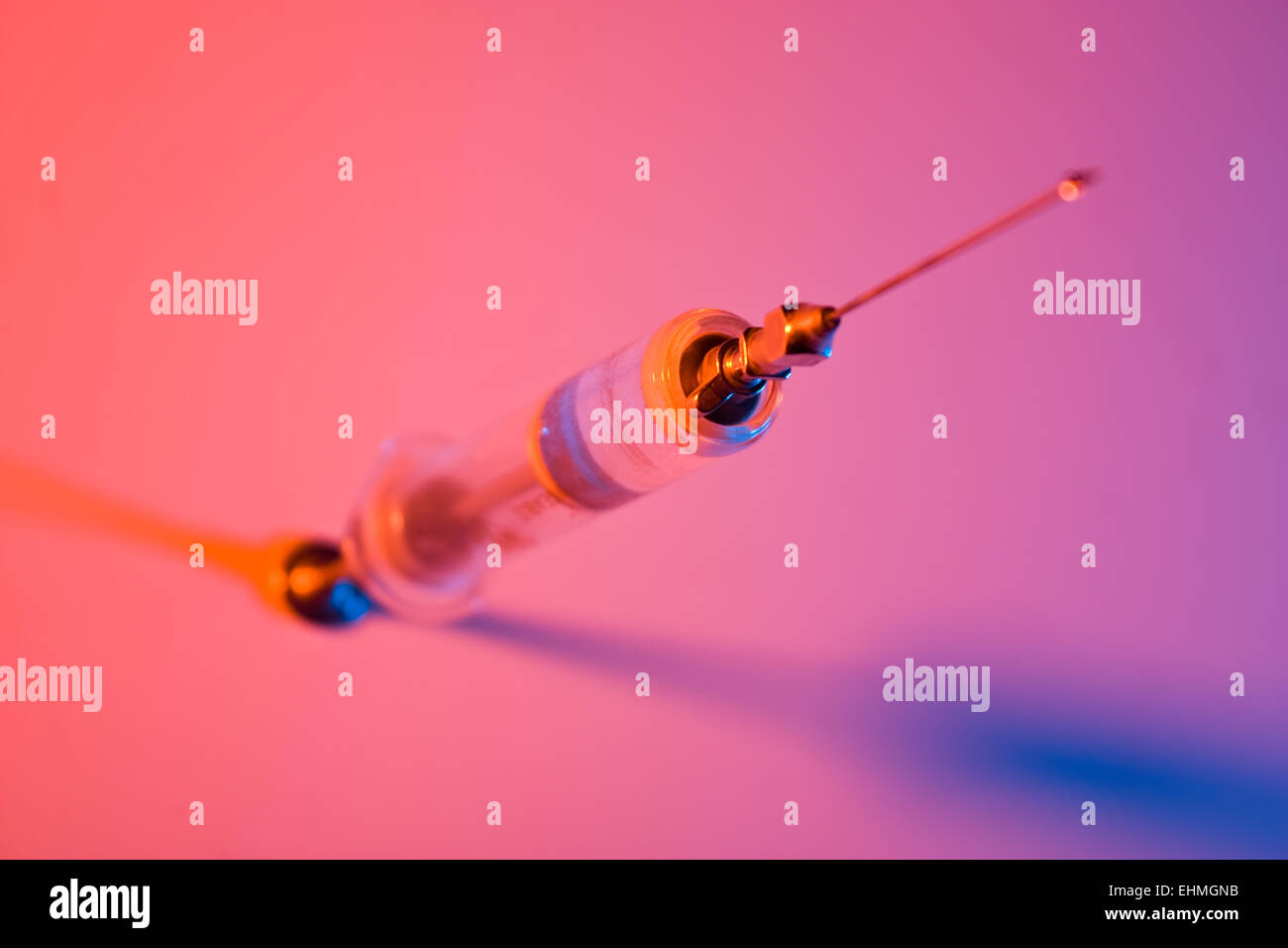 old glass syringe multicolored lights Stock Photo - Alamy