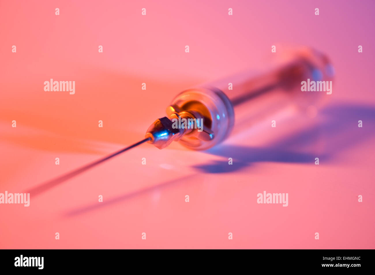 old glass syringe multicolored lights Stock Photo - Alamy