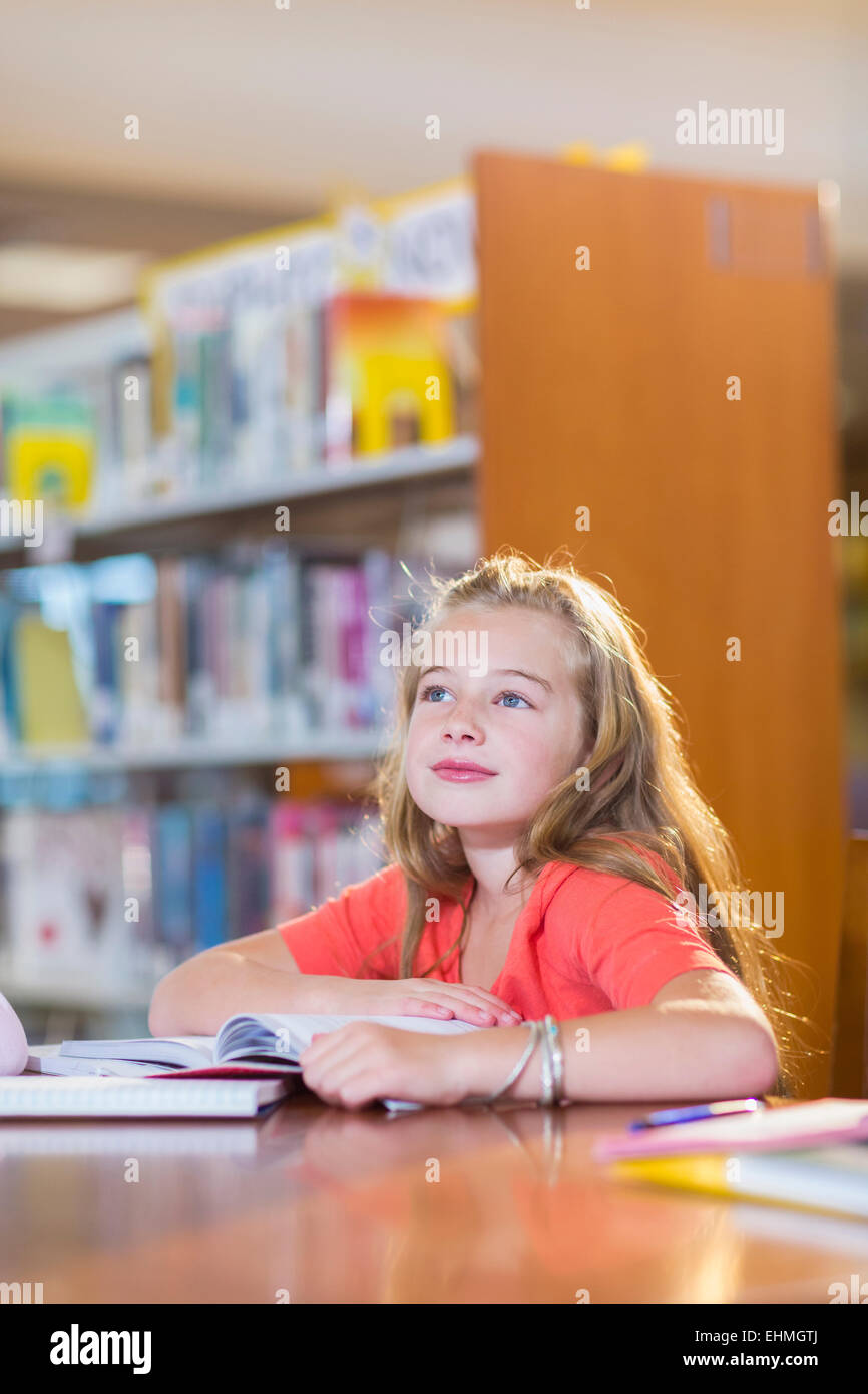 Caucasian student sitting at desk in library Stock Photo - Alamy