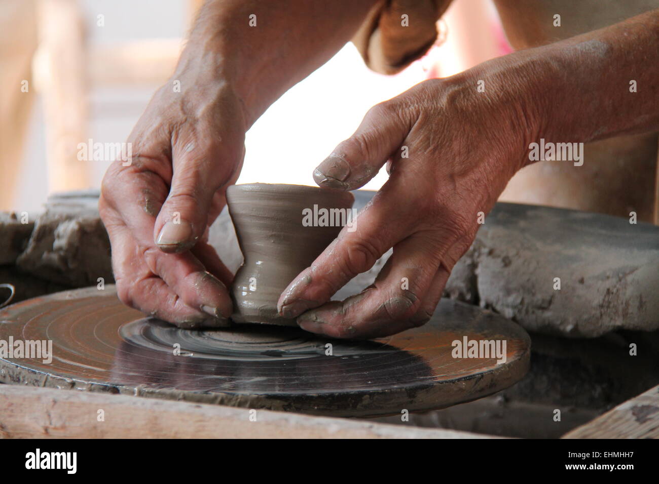 A Clay Pot Being Carefully Lifted from the Potters Wheel Stock Photo ...