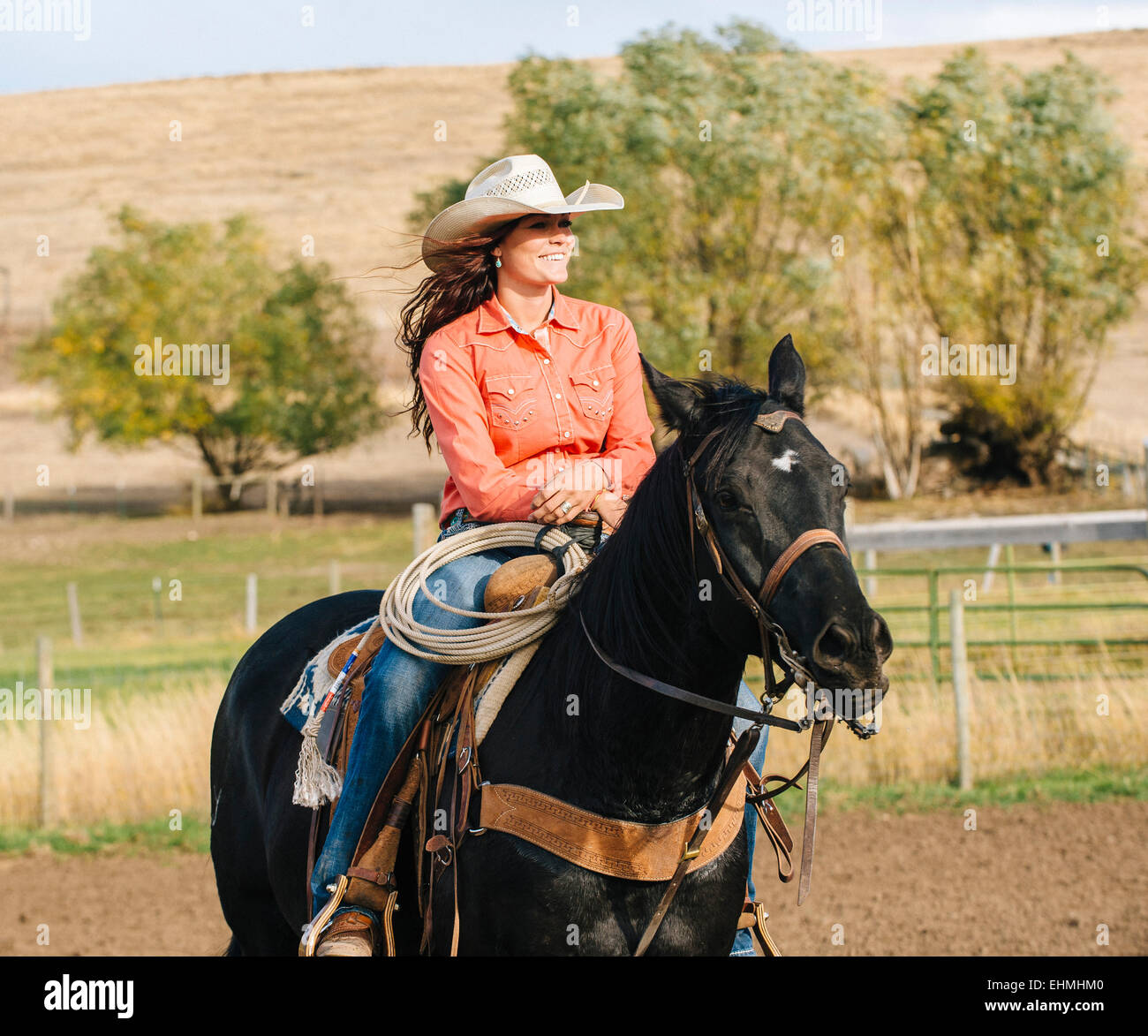 Caucasian woman riding horse on ranch Stock Photo - Alamy