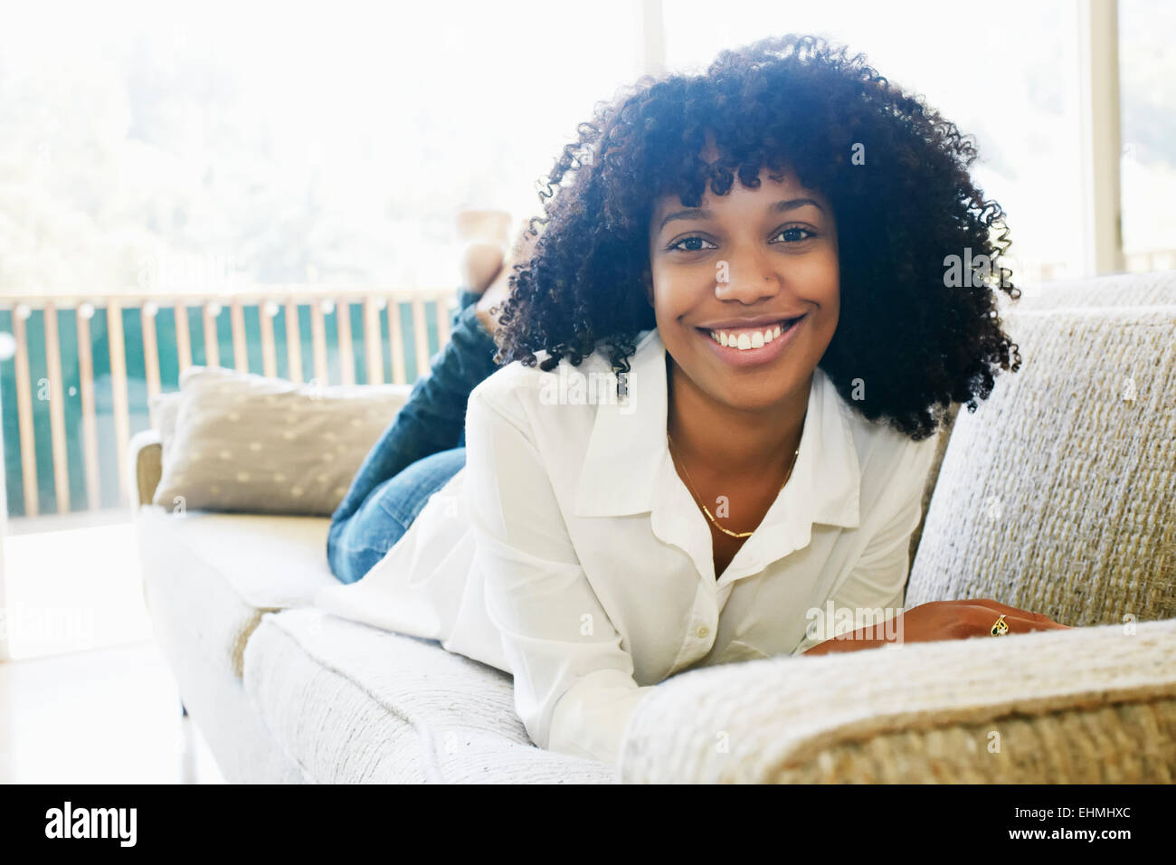 Woman laying on couch one person hi-res stock photography and images ...
