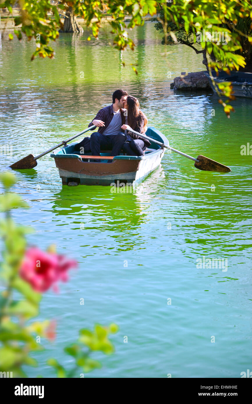 Romantic young couple boating on calm lake Stock Photo - Alamy