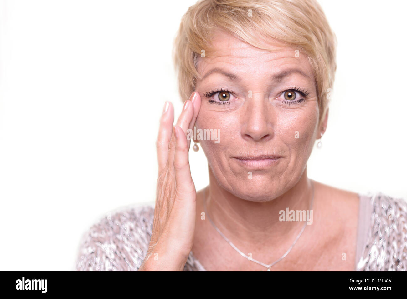 Attractive senior blond woman with a wide-eyed expression and her ...