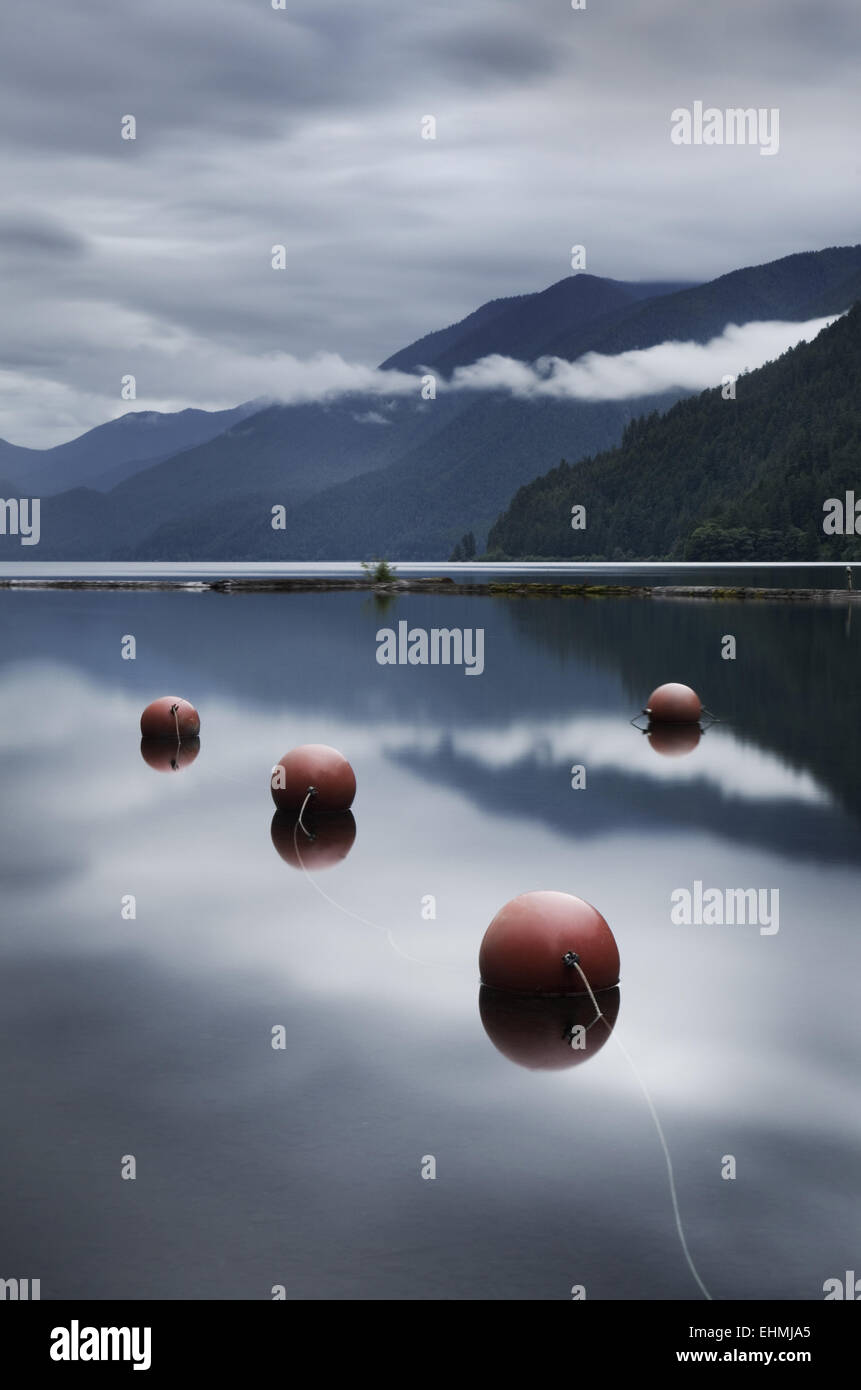 Buoys floating in still remote lake Stock Photo - Alamy