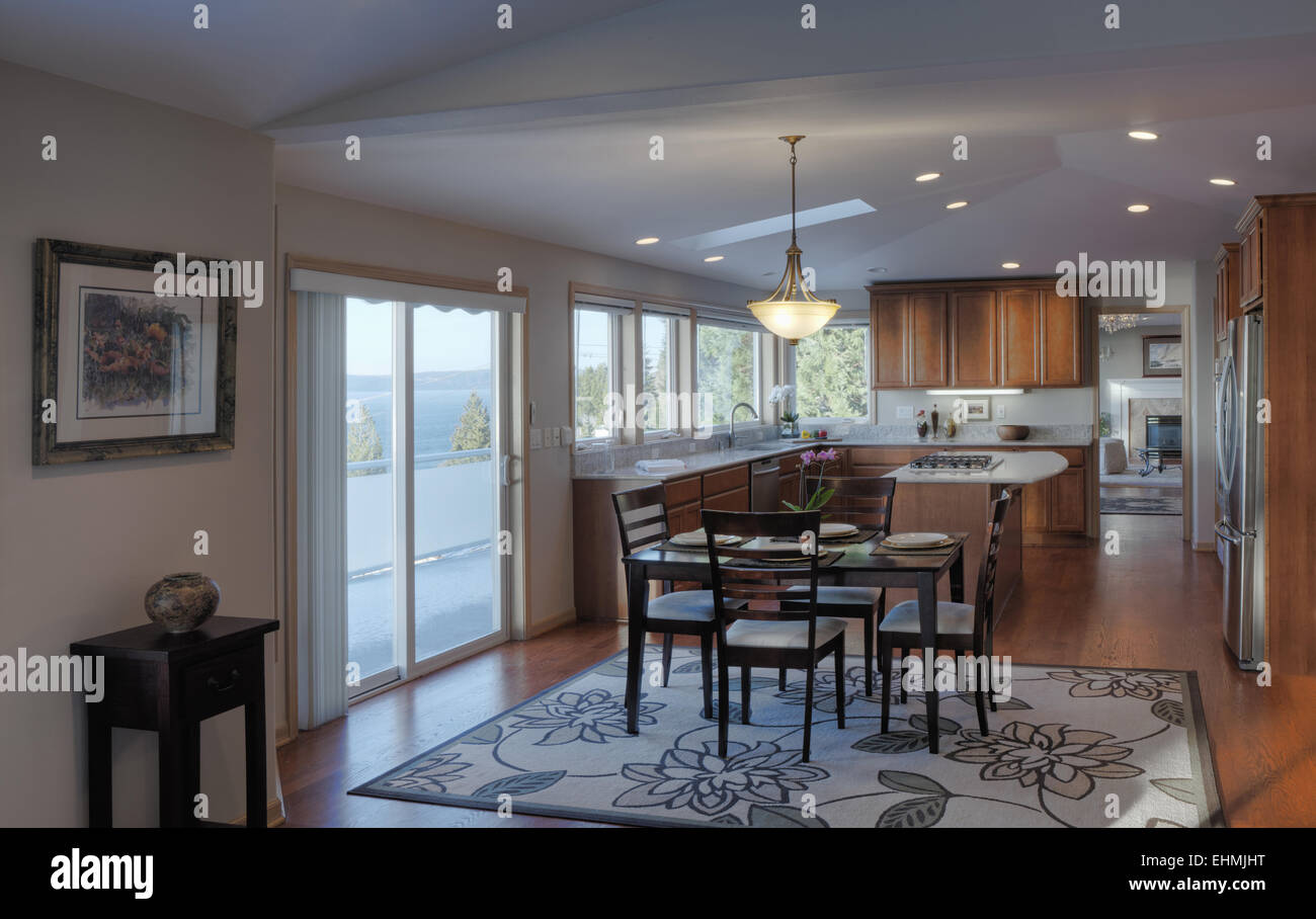 Table and chairs in open kitchen and dining room Stock Photo - Alamy