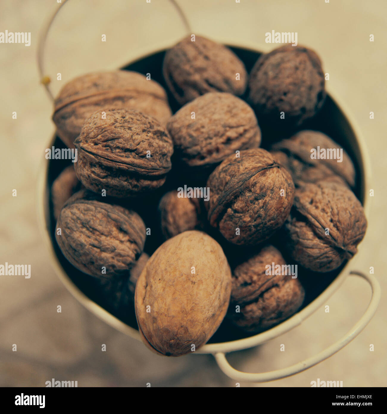 small bowl with walnuts instagram toned yellow Stock Photo - Alamy