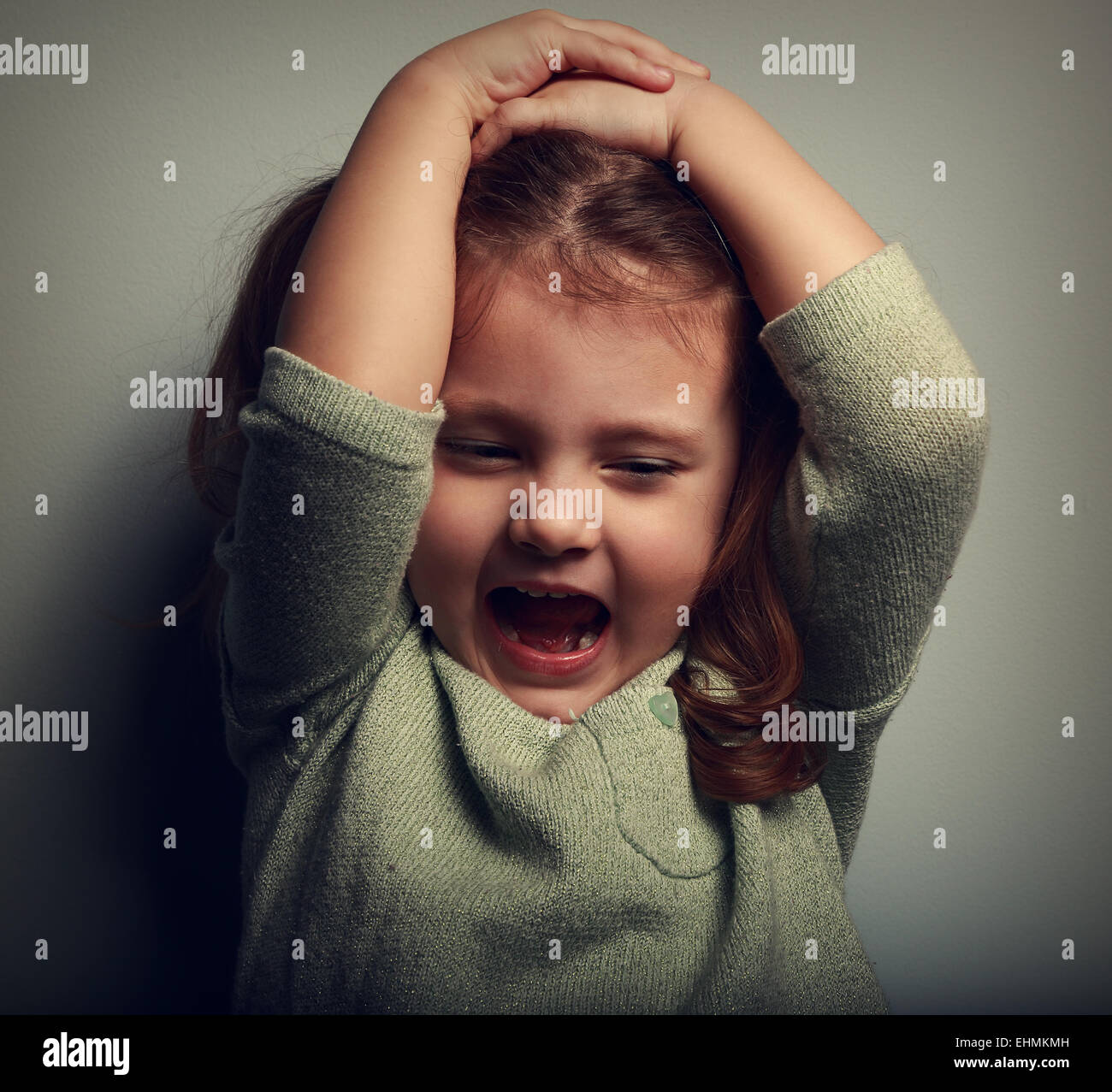 Anger shouting kid holding head with open mouth. Closeup vintage ...