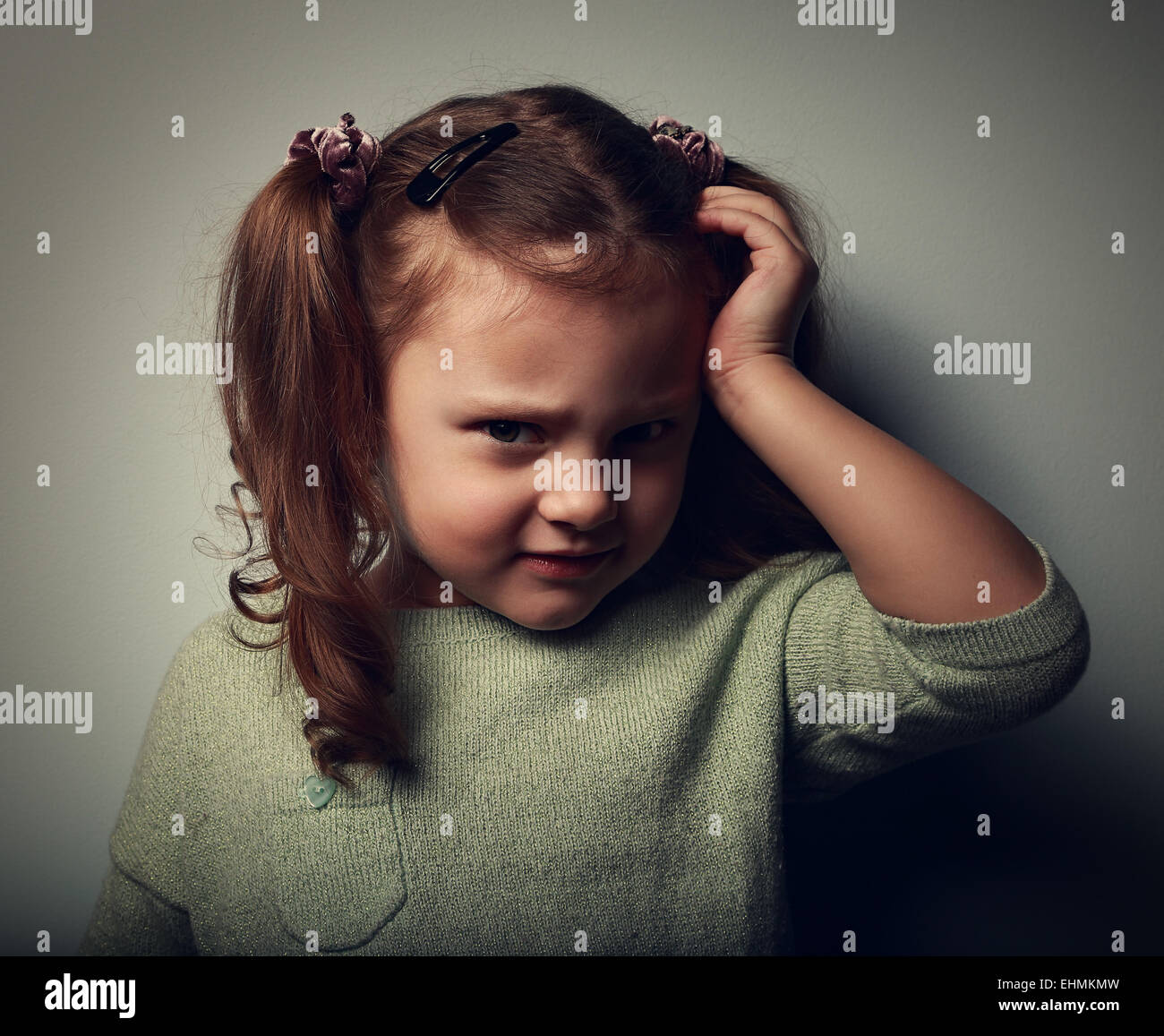 Unhappy kid with headache holding head the head. Vintage closeup ...