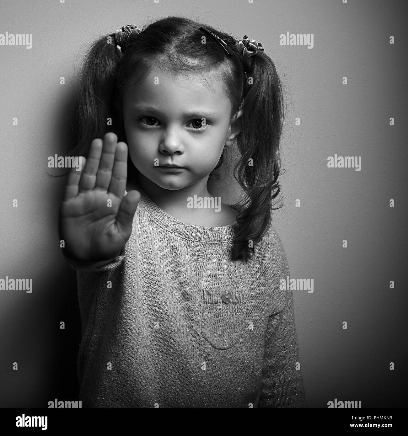 Stop violence against kids. Serious kid showing hand stop sign. Black ...