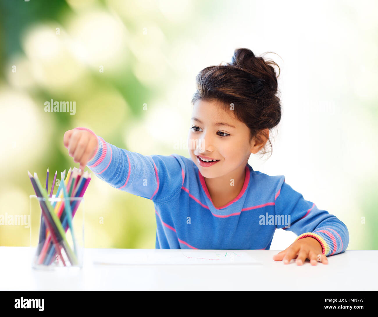 happy little girl drawing with coloring pencils Stock Photo - Alamy