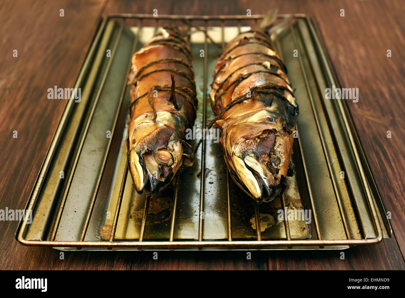 Smoke-dried mackerel fish on lattice, close up view Stock Photo - Alamy