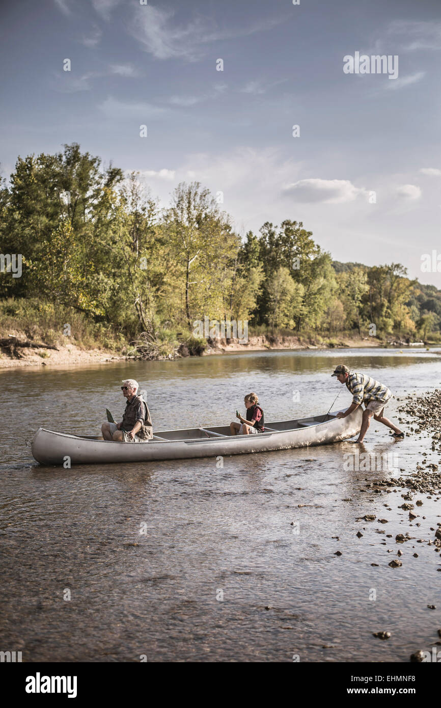Three generations of Caucasian men in canoe on river Stock Photo - Alamy